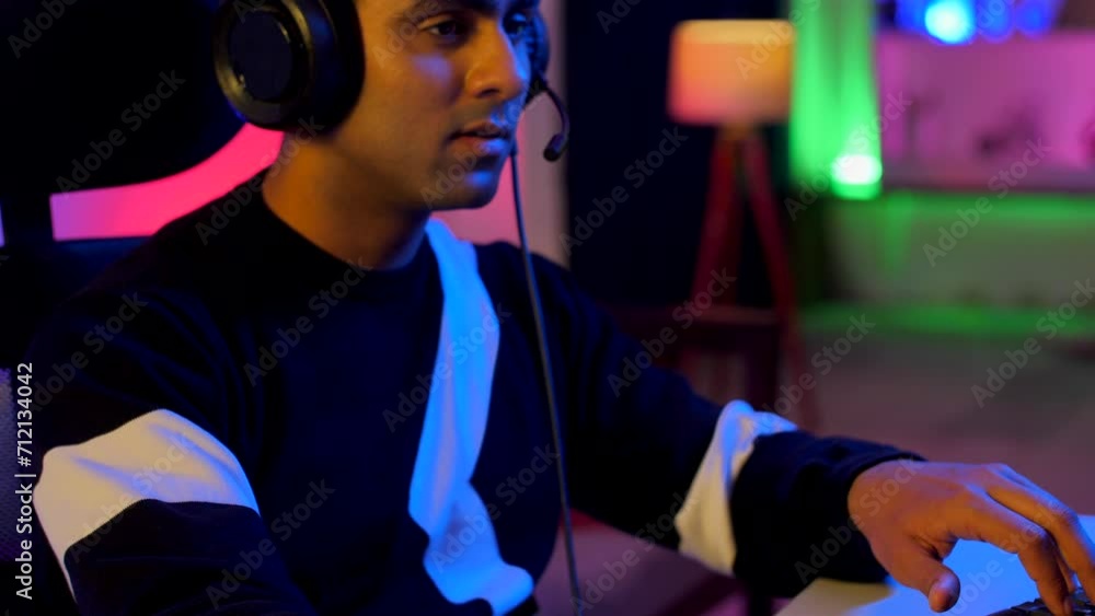 Indian gamer playing video games in a home gaming setup - gaming ...