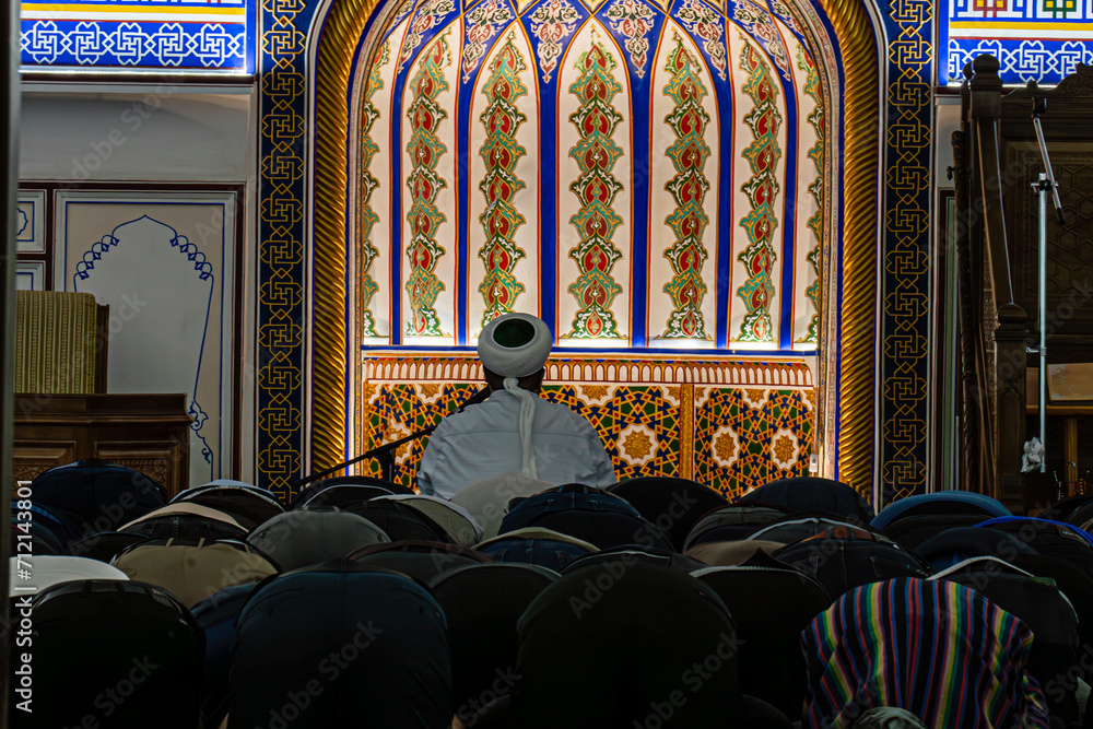 People in a Mosque. Muslims kneeling and bowing down while offering ...