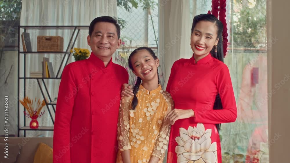 Vidéo Stock Portrait of happy Vietnamese parents hugging their teenage ...