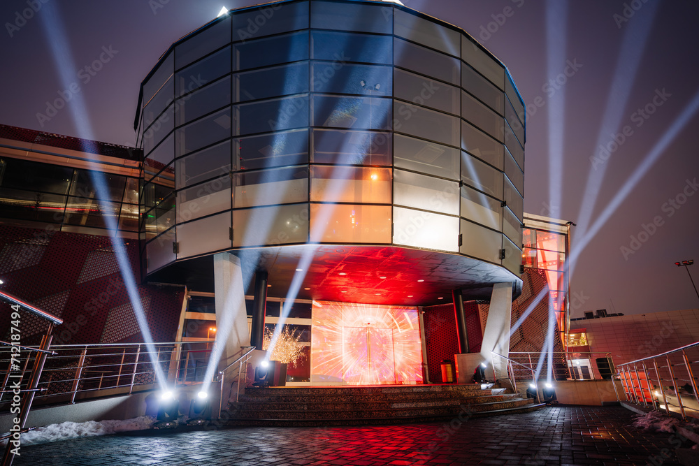 outdoor stage at night with a glowing red LED backdrop and decorative ...