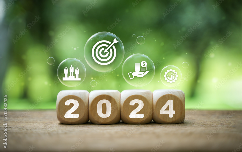 Implementation of the New Year goal plan 2024. Wooden cube with year ...