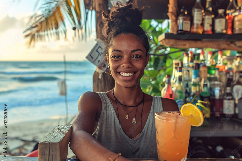 Smiling bartender African girl behind the outdoor bar on the beach ...