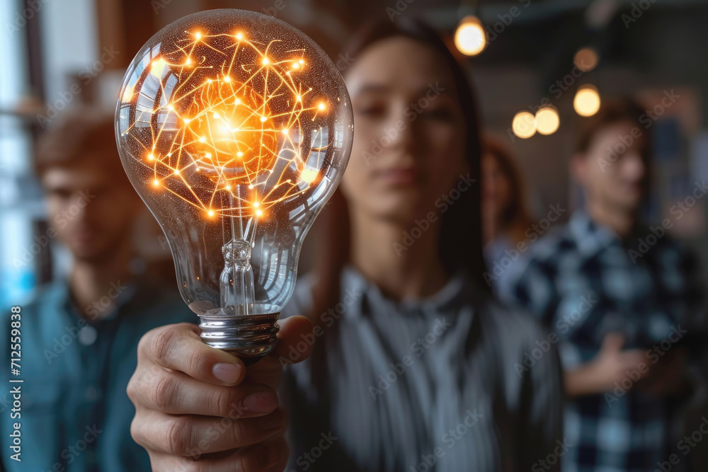 light bulb in hand. "Collaboration in the Office: Teamwork Makes the ...