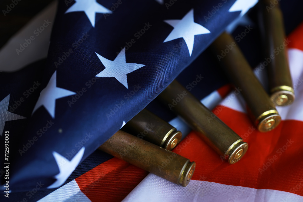 Many bullets cartridges and medals on United States flag. Concept of ...