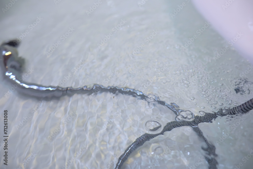 Soap bubbles background. Shampoo foam in the water in the bathroom ...