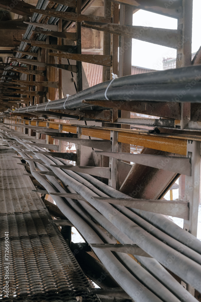 Rows of cable on a cable overpass. Outdoors industrial conduit corridor ...