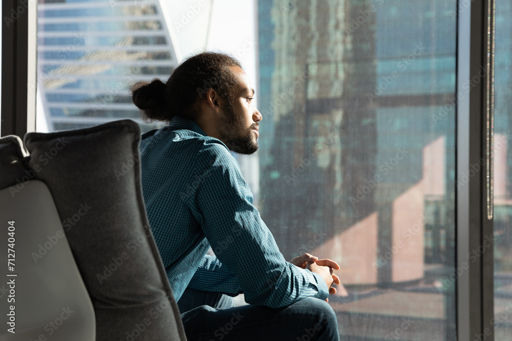 Creating idea. Pensive biracial businessman sit in cozy ergonomic ...