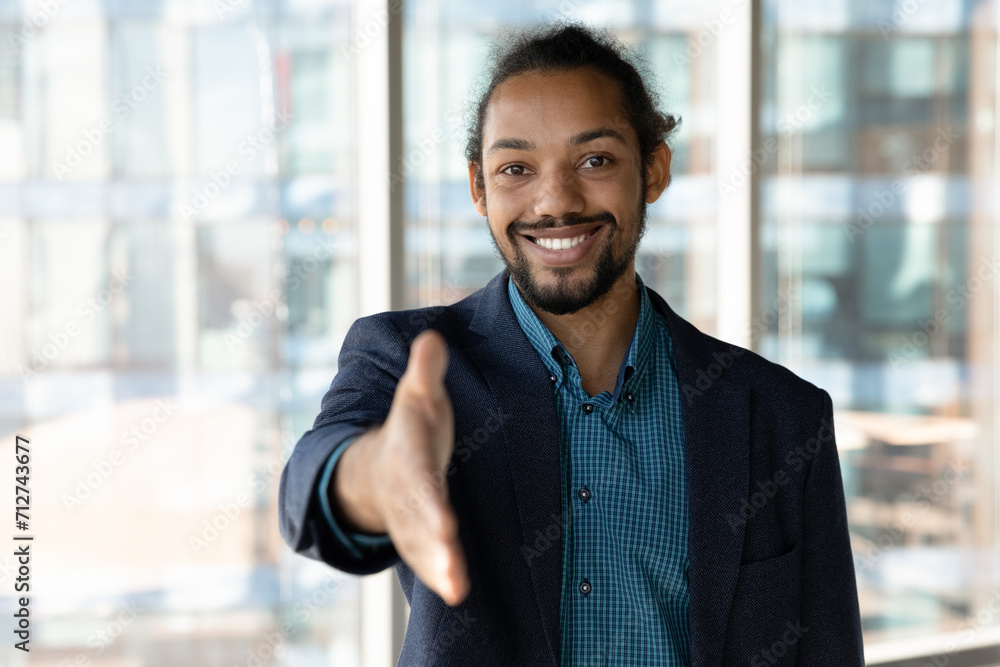 Portrait of happy young black hr manager look at camera stretch hand to ...
