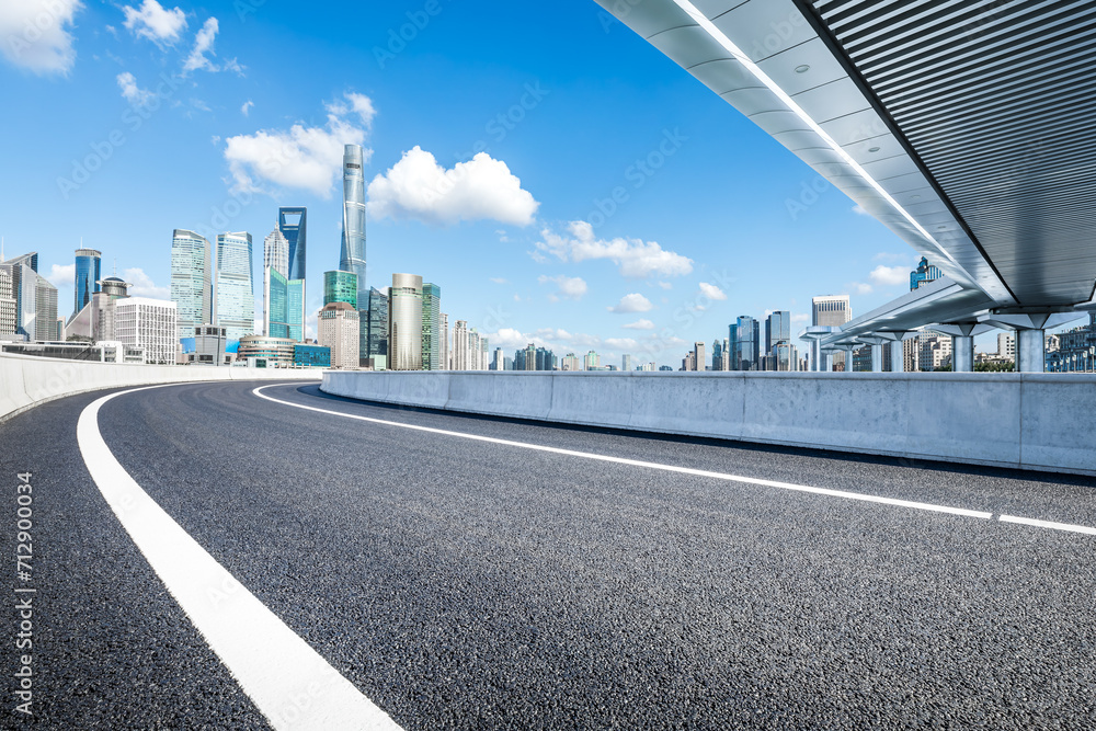 Poster Asphalt highway road and pedestrian bridge with modern city ...