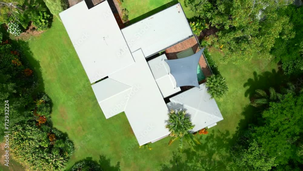 Rotating drone shot of a large rural home with a swimming pool ...