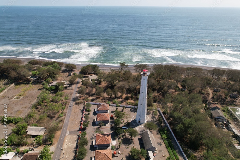 aerial view of white lighthouse. A lighthouse is a tower building with ...