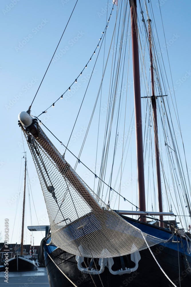 Ship's bow with jib boom and tightly knotted jib net in front of the ...