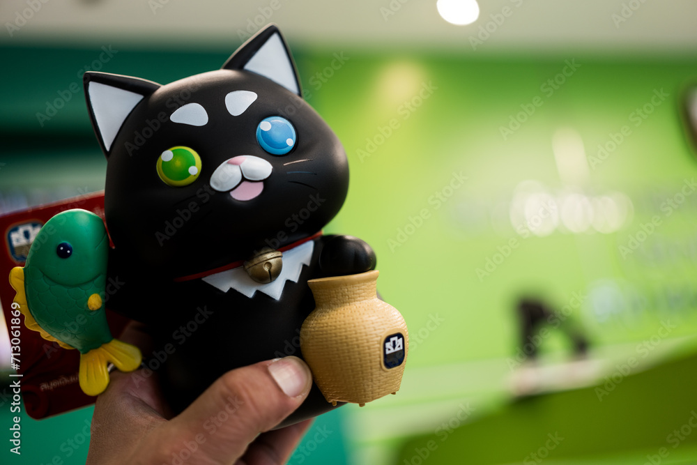 Bangkok, Thailand - Jan 17, 2024 : Money box ME Chok, black cat catches ...