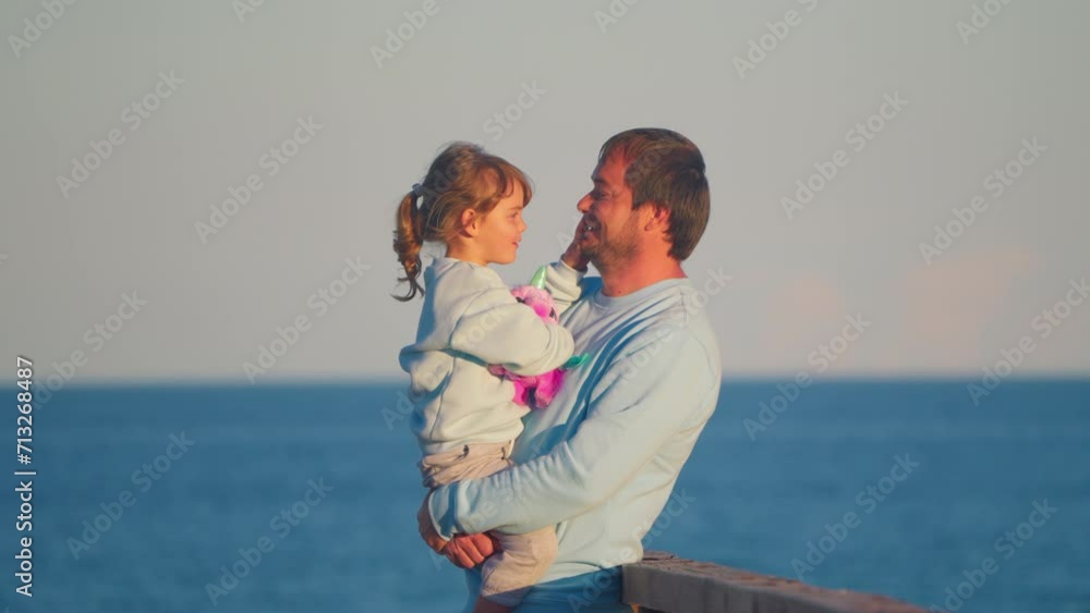 Adult parent man dad and small kid daughter cuddling hugging at outdoor ...