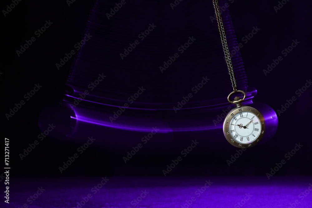 Hypnosis session. Vintage pocket watch with chain swinging over surface ...