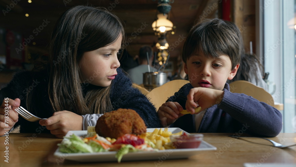 Children eating food at restaurant, siblings - small brother and sister ...