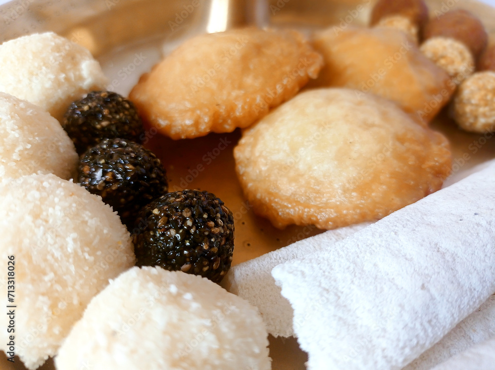 Assamese traditional food items like pitha, laddu, doi sira with ...