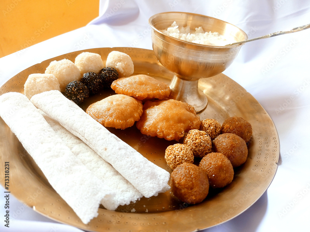 Assamese traditional food items like pitha, laddu, doi sira with ...