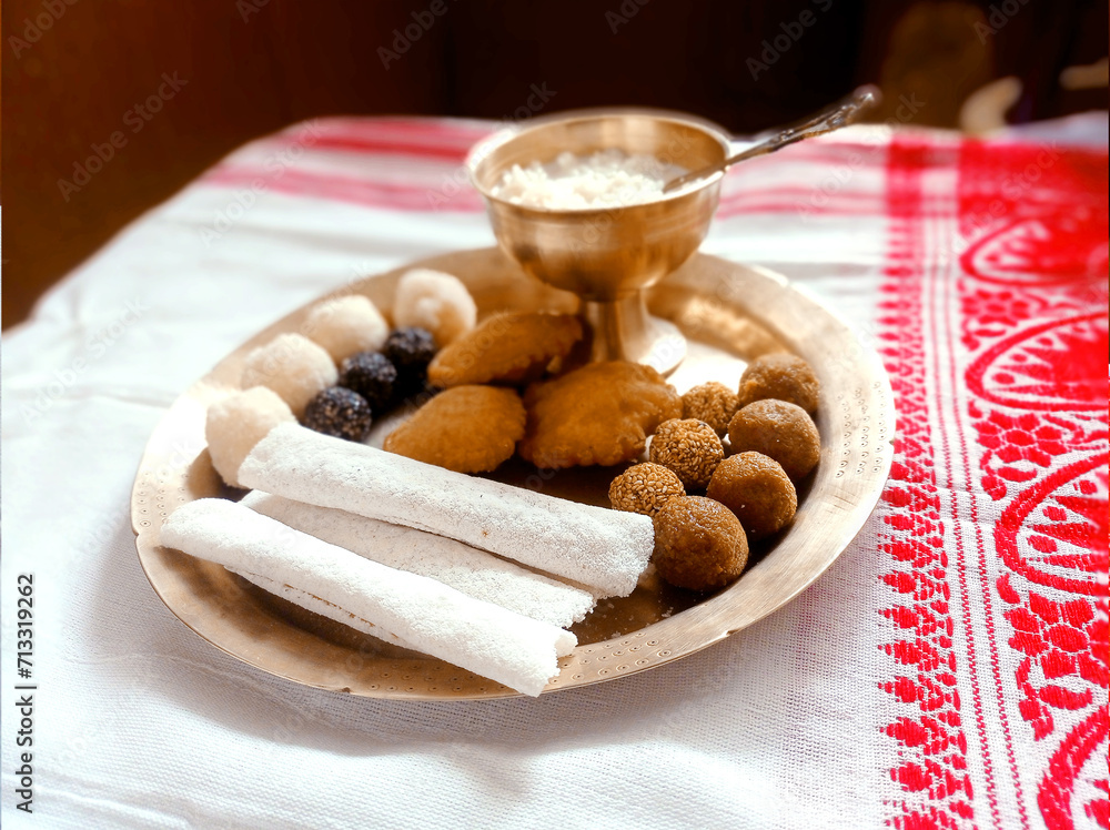 Assamese traditional food items like pitha, laddu, doi sira with ...