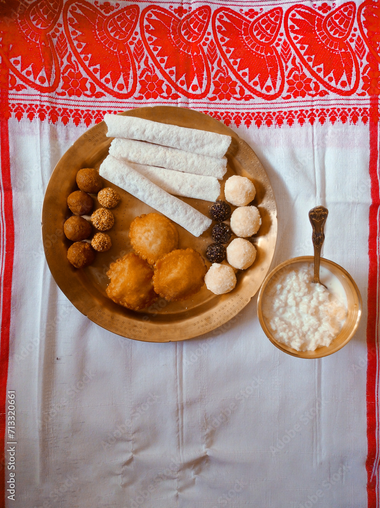 Assamese traditional food items like pitha, laddu, doi sira with ...