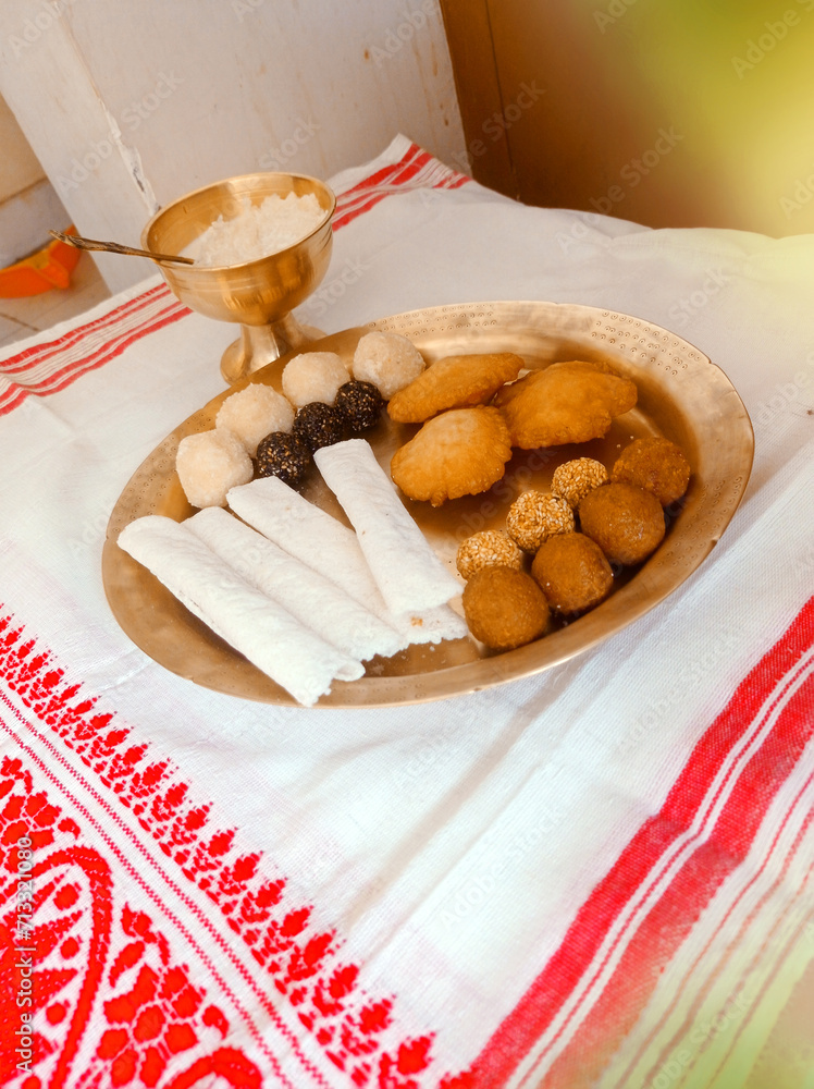 Assamese traditional food items like pitha, laddu, doi sira with ...