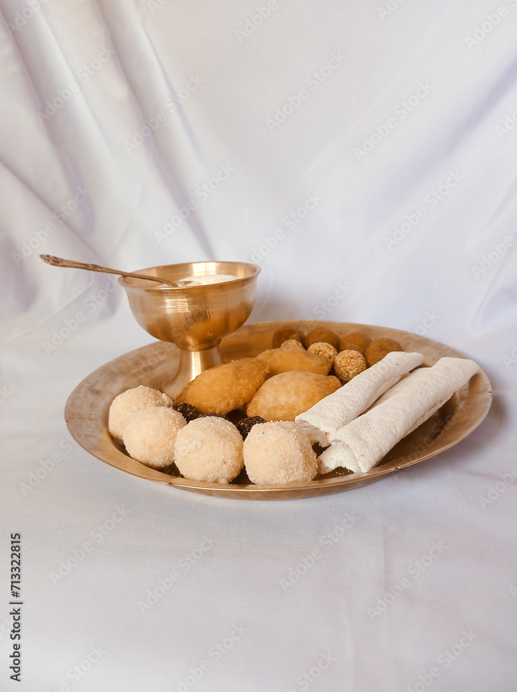 Assamese traditional food items like pitha, laddu, doi sira with ...