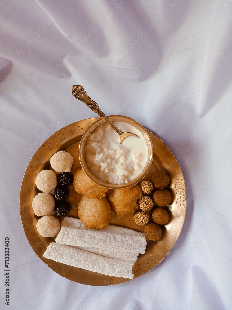 Assamese traditional food items like pitha, laddu, doi sira with ...