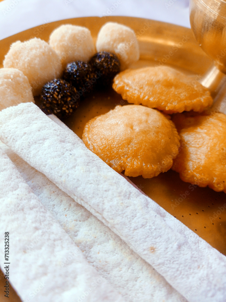 Assamese traditional food items like pitha, laddu, doi sira with ...