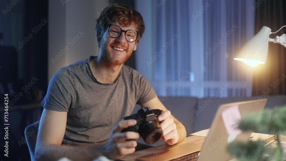 Handsome red haired young man photographer hold digital camera looking ...