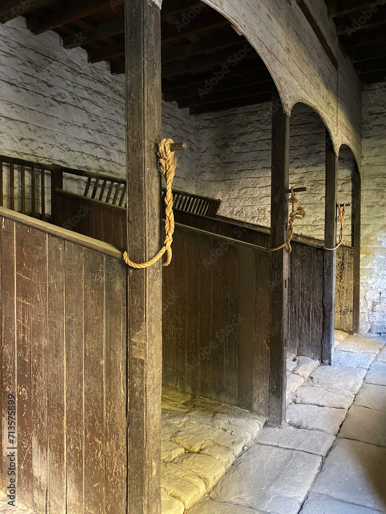 Centuries-old stable with empty wooden stalls. Antique barn. Ancestral ...