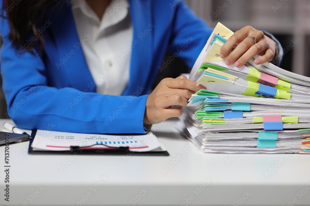 Businesswoman hands working in Stacks of paper files for searching and ...