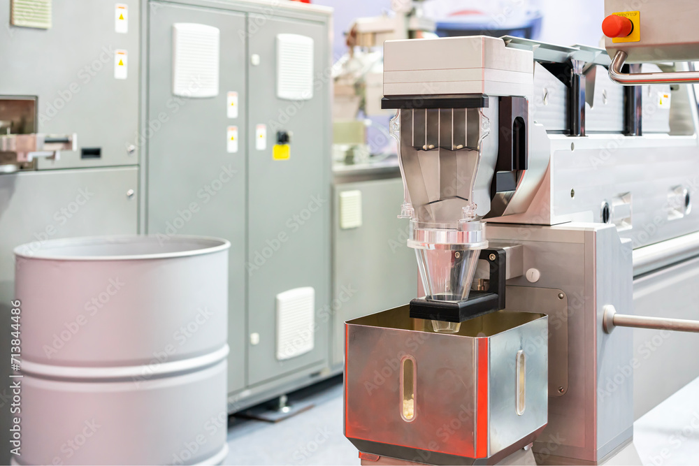 Close up discharge hopper of automatic pill capsule or tablet counting ...