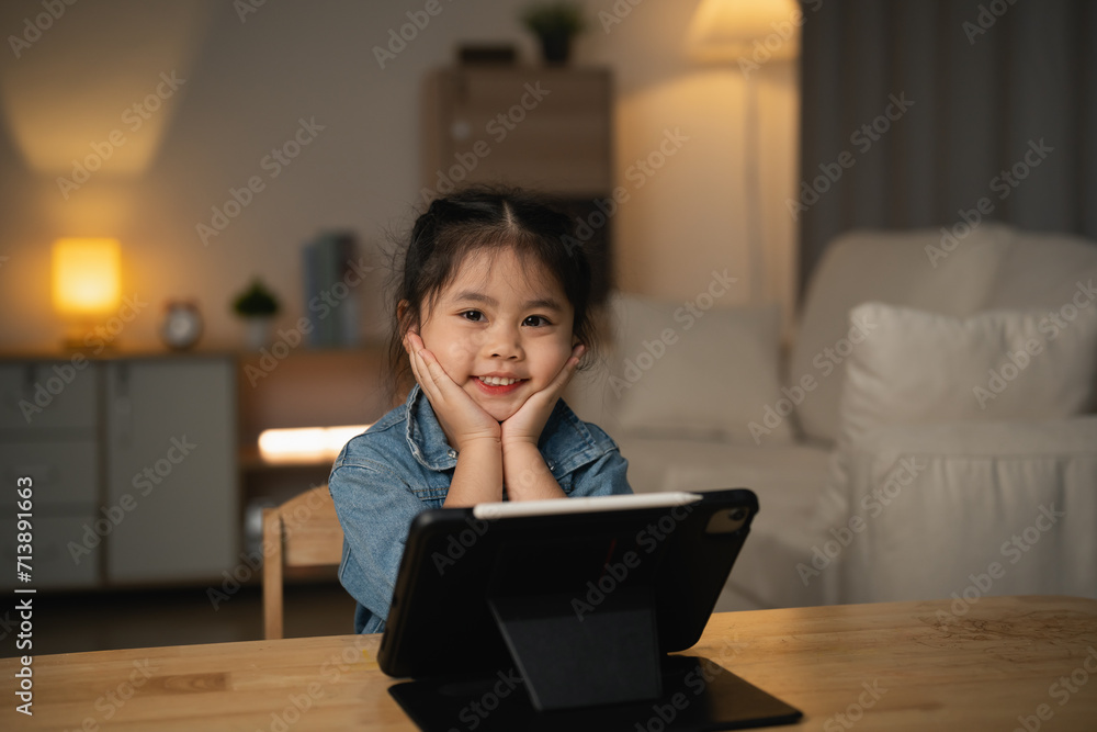 Asian child girl looking using and touch tablet display screen. Baby ...