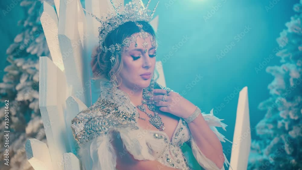 Fantasy woman snow queen sits on ice throne, white dress cape bird ...