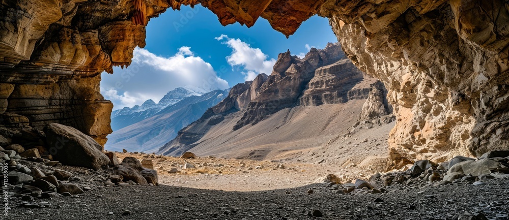 Amidst the rugged desert landscape, a majestic cave emerges from the ...