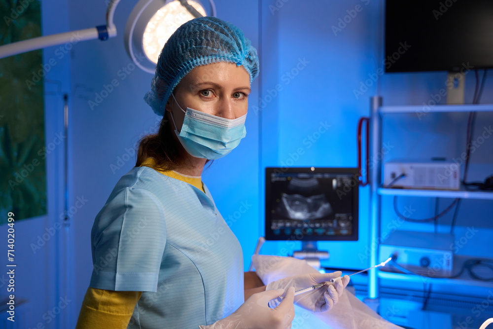 Female doctor using syringe for embryo transfer in reproductive clinic ...