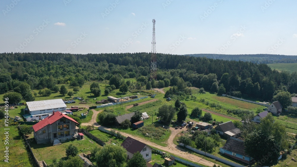 Cell tower in rural area surrounded by forest. Satellite communication ...
