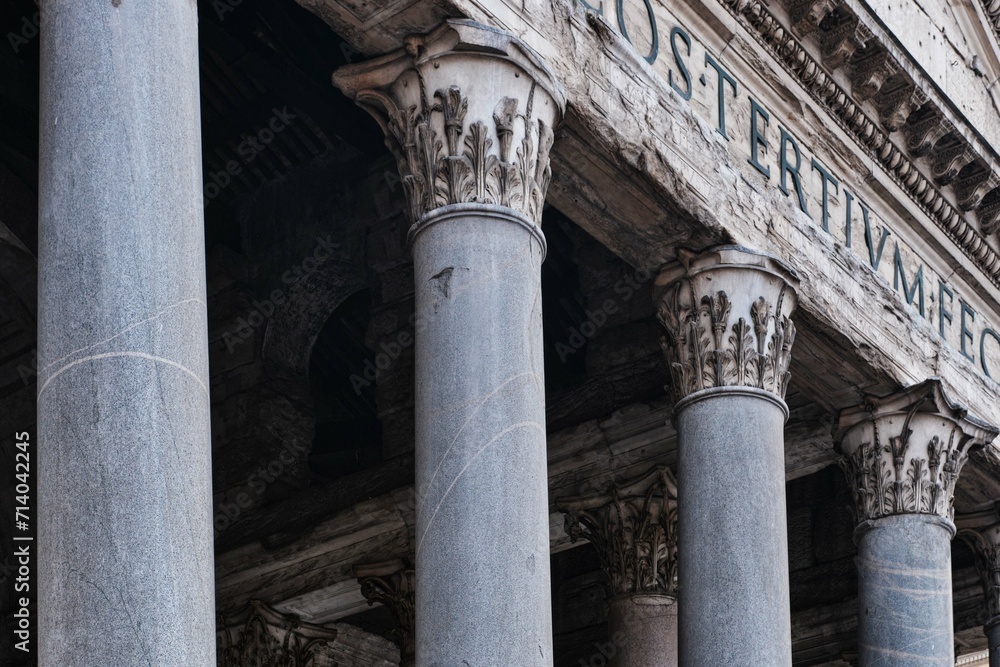 Imposing facade of the ancient Pantheon temple and column capital with ...
