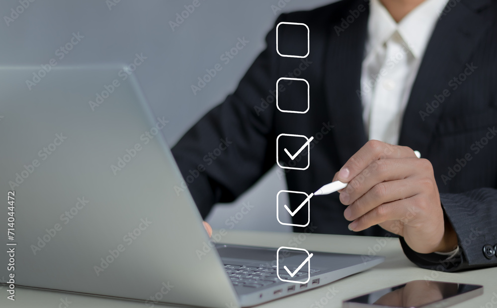 Check list concept.Businessman using laptop with online checklist ...