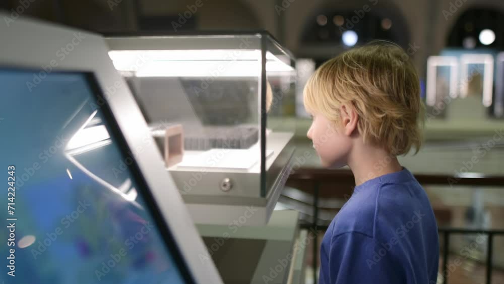 A child of primary school age visiting a science and tech museum. The ...