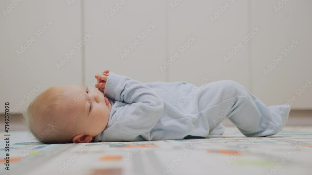 Child development, turning over before crawling. The baby boy is lying ...