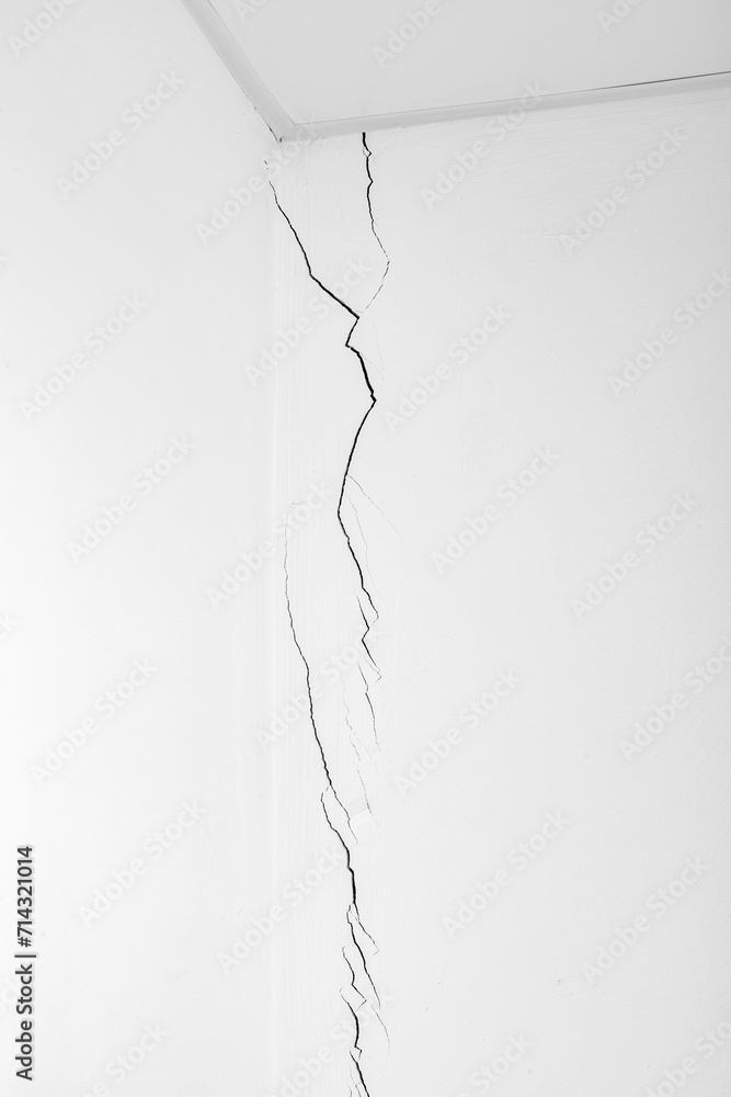 Long, deep crack in the white wall. Construction problems. Shrinkage of ...