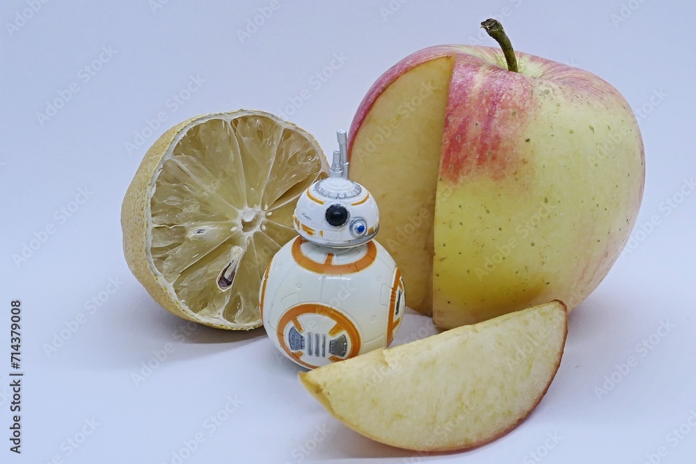 Star Wars model of spherical droid BB-8 standing next to sliced older ...