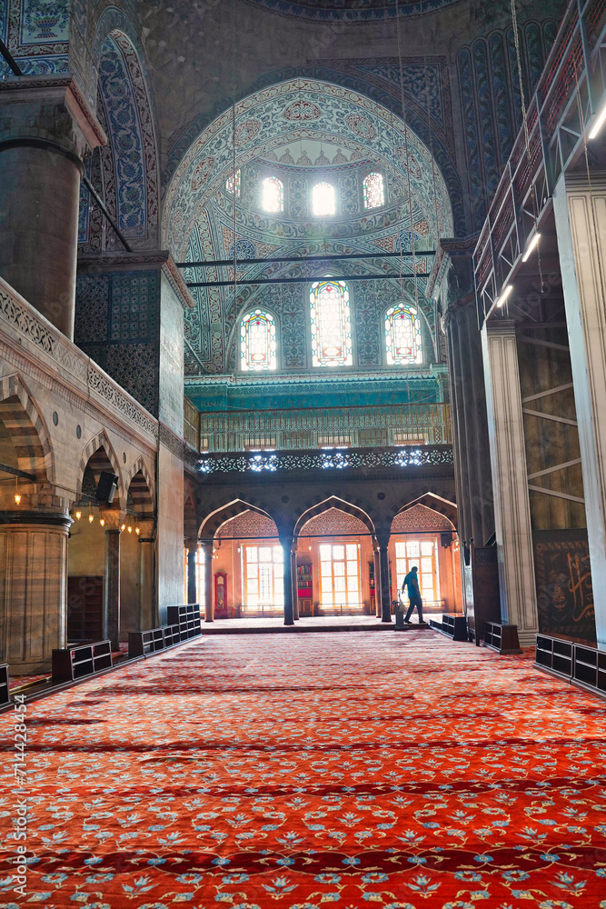 Sunlight streams through the trellised and arched windows of the ...