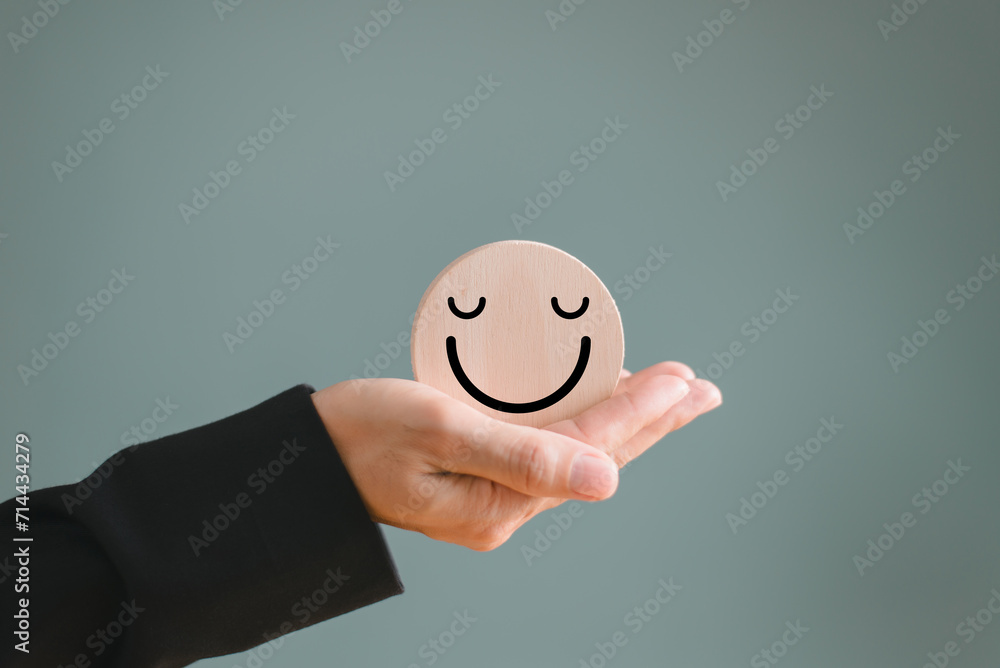 World mental health day. Wooden happy smile relax face on hand people ...
