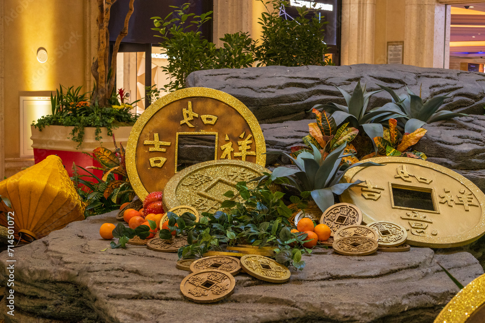 Large gold coins surrounded by lush green plants and colorful flowers ...