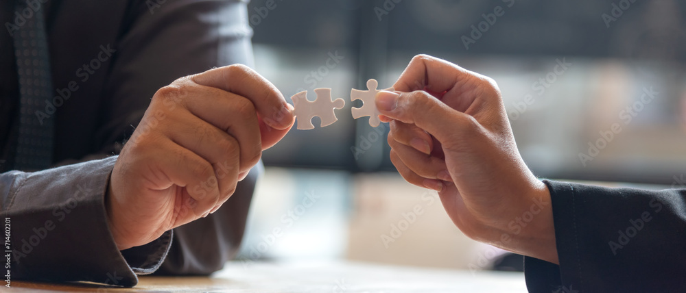 Close up Business team work holding two jigsaw connecting couple puzzle ...