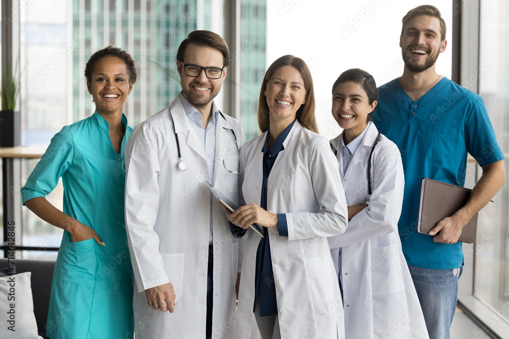 Multiethnic team of happy cheerful young practitioners, surgeons ...