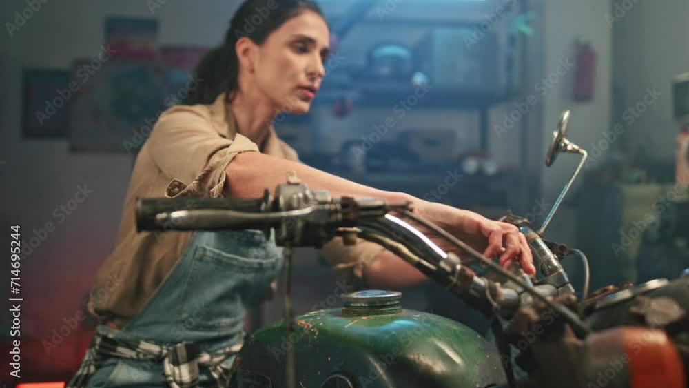 Close up of retro motorbike. Smiling woman reviewing and holding ...