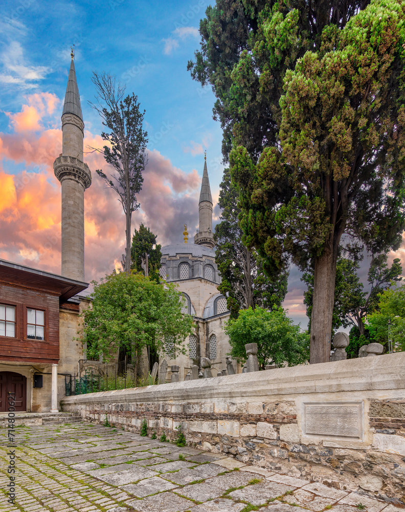 16th century Atik Valide Mosque, surrounded by tall lush trees, located ...